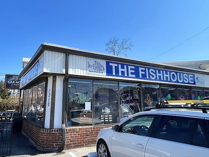 The unassuming exterior of The Fish House belies the seafood treasures within. Blue signage and simple storefront—culinary magic happens here. 