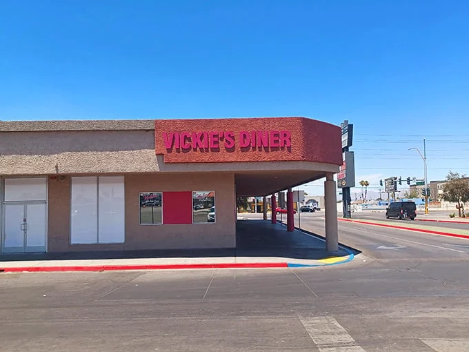 The unmistakable red-and-white exterior of Vickie's Diner stands like a time capsule amid the desert landscape, promising comfort food salvation to weary Vegas travelers.