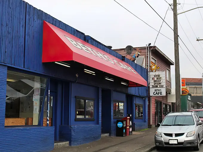 Beth's unmistakable blue exterior with its bold red awning promises comfort food paradise without the pretentious frills—Seattle's answer to diner heaven.
