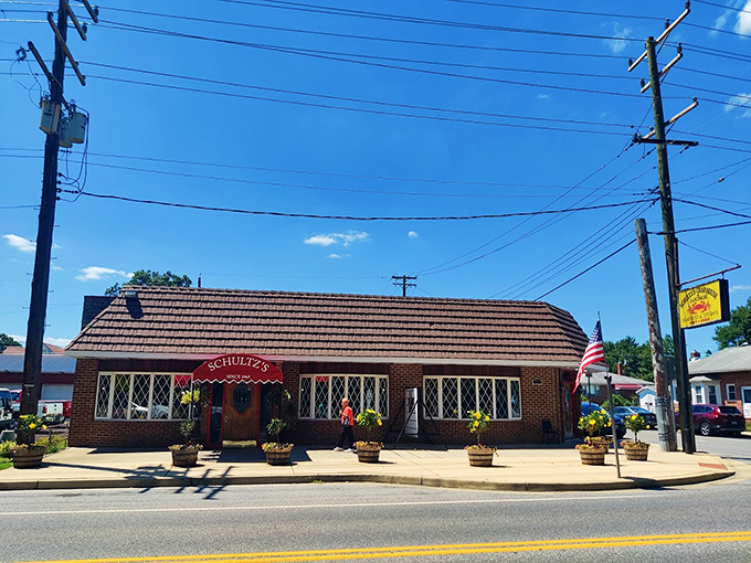 The welcoming entrance to Schultz's, with its cheerful red awning and flower barrels, feels like being invited to a crab feast at a friend's home.