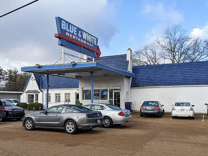 The iconic Blue & White sign stands like a beacon for hungry travelers, promising comfort food under that nostalgic gas station canopy.