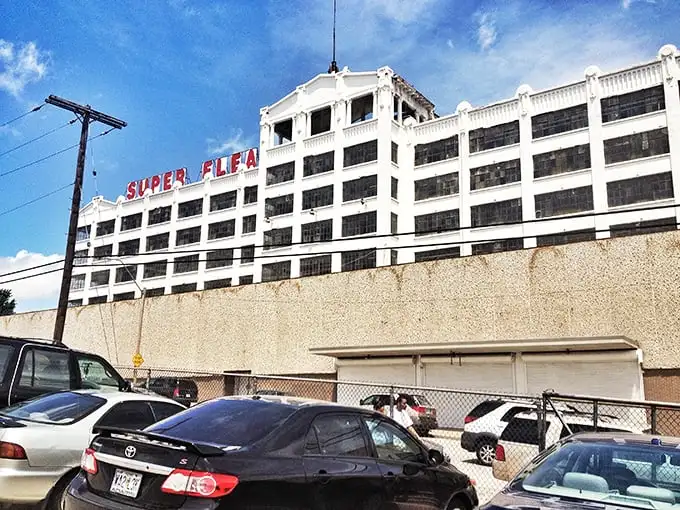 The imposing white fortress of Super Flea stands against a brilliant blue Missouri sky – a siren call to bargain hunters and collectors alike.