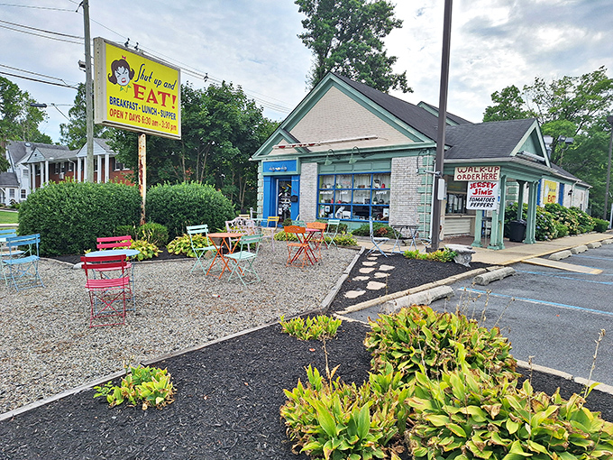 The mint-green exterior of Shut Up and Eat beckons hungry travelers with colorful outdoor seating and a sign that gets straight to the point.