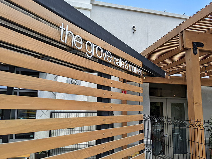The wooden slat exterior of The Grove isn't just stylish—it's a preview of the warmth waiting inside, like a delicious secret the building can barely contain.