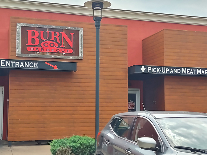The wooden facade of barbecue paradise beckons with its bold red sign – a siren call to meat lovers that promises smoky delights within.