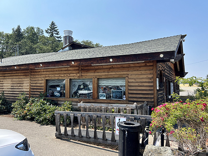 The rustic log cabin exterior of Heaven on Earth Restaurant stands as a beacon for hungry travelers on I-5, promising comfort food salvation in Azalea.