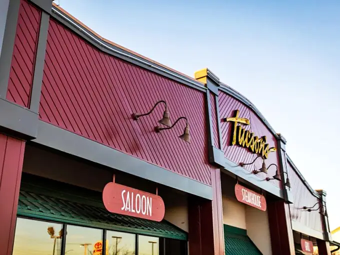 The burgundy facade of Tucson's glows with promise, like a beacon calling to hungry travelers. Those illuminated signs aren't just decoration—they're a dinner invitation you can't refuse.