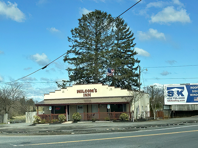 The unassuming exterior of Wilcom's Inn stands as a culinary speakeasy—proof that the best flavors often hide behind the simplest facades.