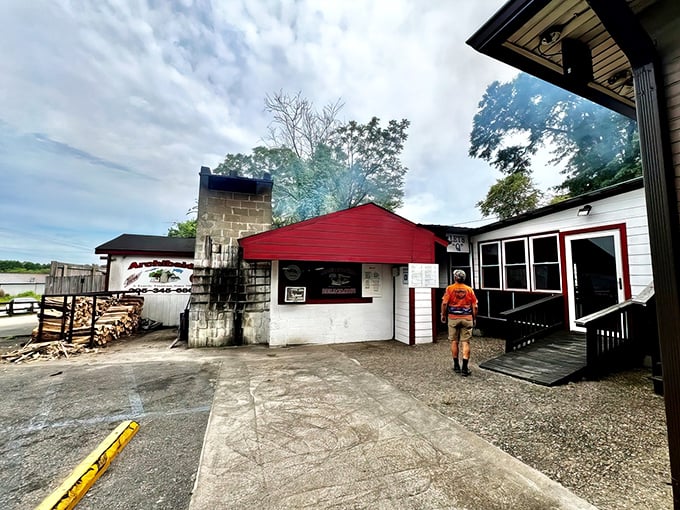The humble cinderblock fortress that launched a thousand BBQ pilgrimages. Hickory wood stacked outside promises smoky delights within.