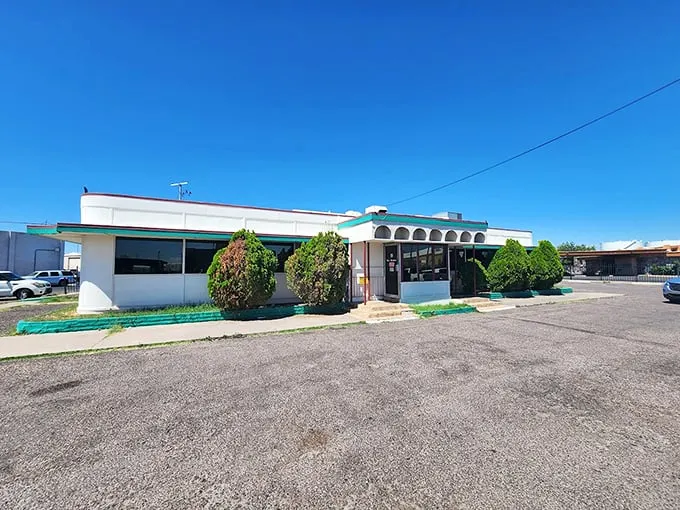 The classic roadside silhouette of Mel's Diner stands proudly against Arizona's impossibly blue sky, a time capsule of Americana waiting to welcome hungry travelers.