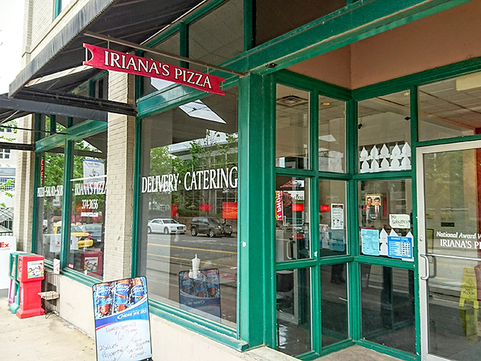 The unassuming storefront of Iriana's Pizza stands like a beacon of hope for hungry downtown Little Rock wanderers. Simple green frames, bold red sign—pizza paradise awaits.