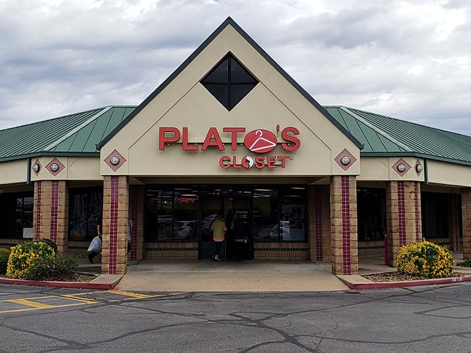 The distinctive green-roofed exterior of Plato's Closet in Fayetteville welcomes fashion hunters with the promise of treasures within.