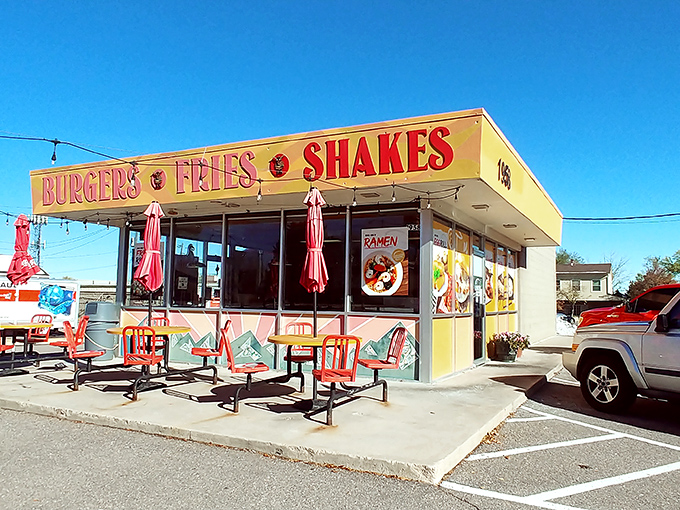 The sunshine-yellow exterior of Big Sky Burger stands out like a beacon for hungry travelers, promising simple pleasures with its no-nonsense "BURGERS • FRIES • SHAKES" declaration.