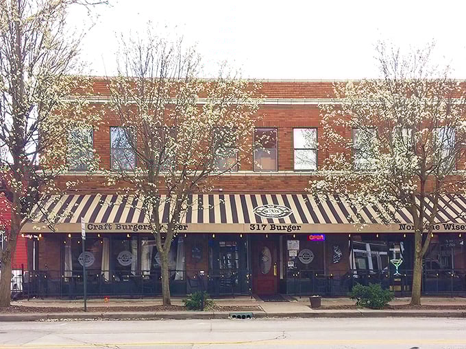 The iconic black and gold striped awning of 317 Burger beckons hungry travelers like a lighthouse for the famished. "Craft Burgers & Beer" isn't just a promise—it's a mission statement.