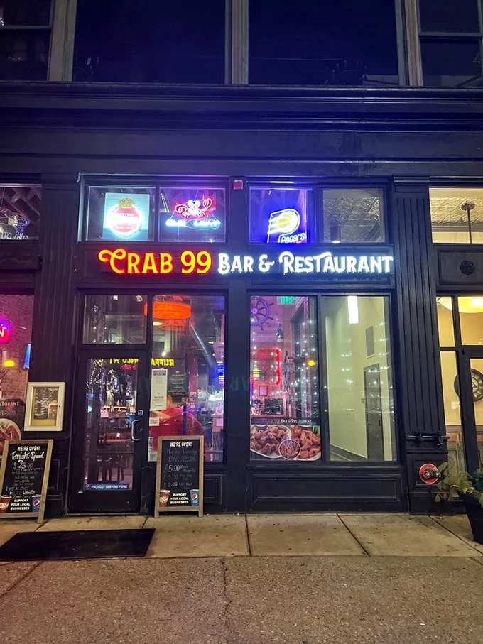 The neon glow of Crab 99's sign cuts through the night like a lighthouse for seafood-starved Midwesterners, promising oceanic treasures in downtown Indy.