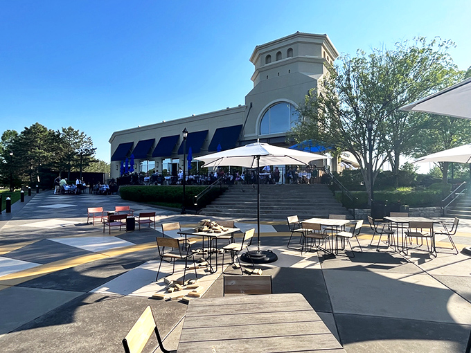Newport Grill's exterior welcomes you with cheerful blue umbrellas and a sunny patio—like the Mediterranean coast decided to vacation in Kansas.