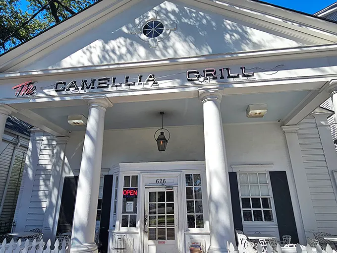 The Greek revival façade of Camellia Grill stands like a culinary Parthenon, welcoming hungry pilgrims to this temple of comfort food since 1946.