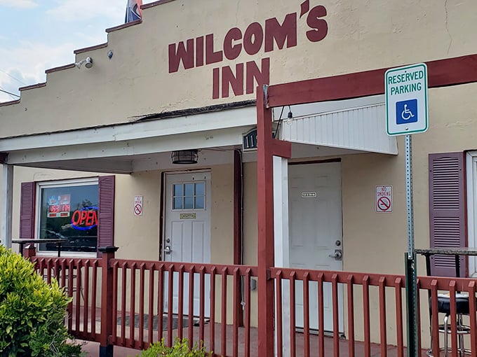 The unassuming exterior of Wilcom's Inn stands as a culinary speakeasy—proof that the best flavors often hide behind the simplest facades.