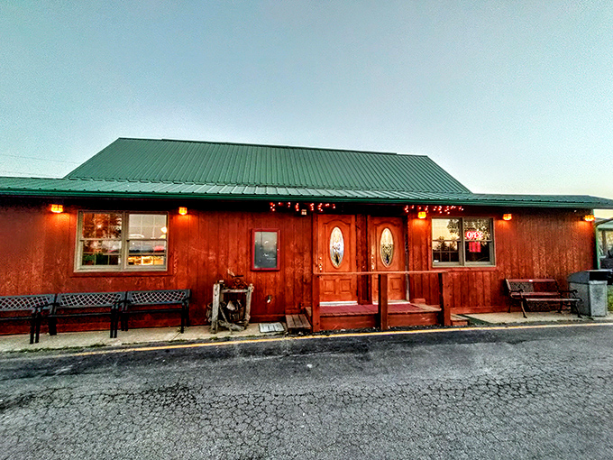 The red-stained timber exterior of Rustic Oak beckons like a carnivore's lighthouse in rural Missouri—rustic benches inviting you to sit a spell before the feast begins.
