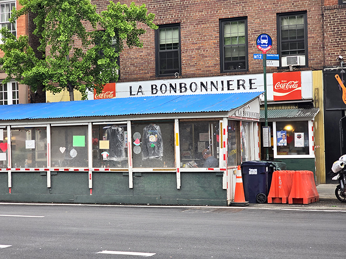 La Bonbonniere's weathered façade stands as a time capsule in the West Village, its vintage sign promising the holy trinity of comfort: burgers, snacks, and fountain treats.