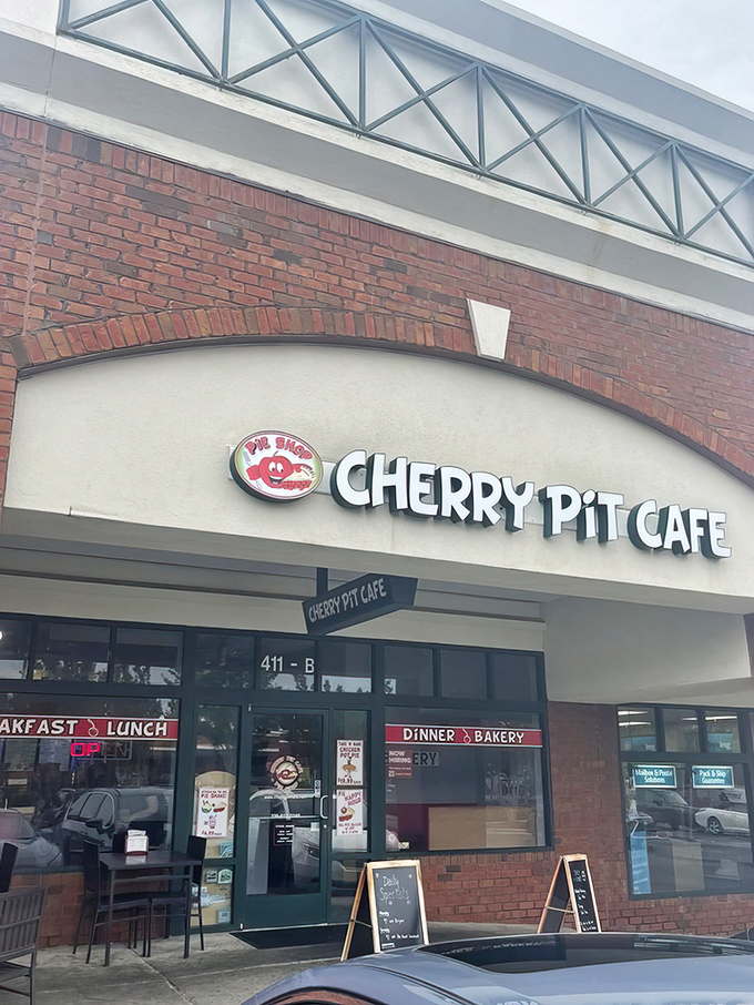 The bright signage of Cherry Pit Cafe promises comfort before you even walk through the door. Like finding a $20 bill in an old jacket pocket—unexpectedly delightful.