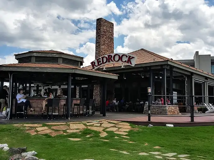 Stone meets sky at Redrock Canyon Grill, where that impressive chimney isn't just for show—it's the beacon that guides hungry Oklahomans home.