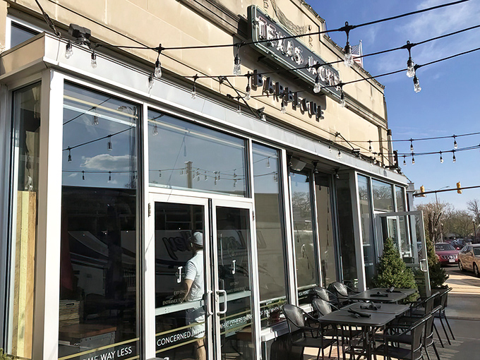 The inviting exterior of Texas Jack's Barbecue beckons with its vintage-style neon sign and string lights—like a beacon of smoky salvation on Arlington's Washington Boulevard.