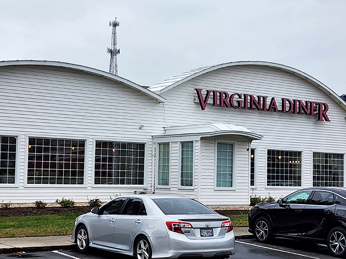 The white curved-roof building with bold red "VIRGINIA DINER" lettering stands proudly against the sky, like a beacon of comfort food calling road-weary travelers home.