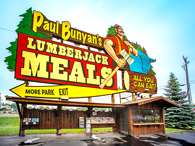 The legendary Paul Bunyan welcomes hungry travelers with a sign that practically shouts "FOOD!" louder than a lumberjack yelling "TIMBER!"