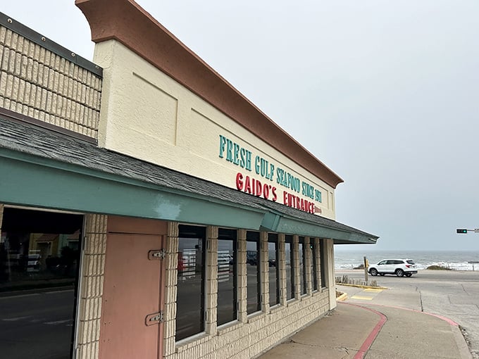 The iconic blue crab perched atop Gaido's isn't just decoration—it's a siren call to seafood lovers that says, "The Gulf's treasures await inside."