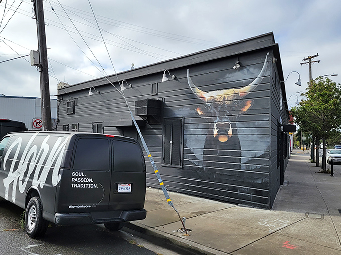 The unassuming exterior of Horn BBQ in Oakland – where that bold white lettering against dark panels is the architectural equivalent of a whisper about the best-kept secret in town.