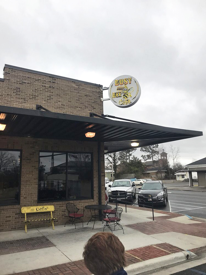 The humble brick exterior of Busy Bee Café stands like a beacon of breakfast hope, its cheerful yellow sign promising delicious revelations within.