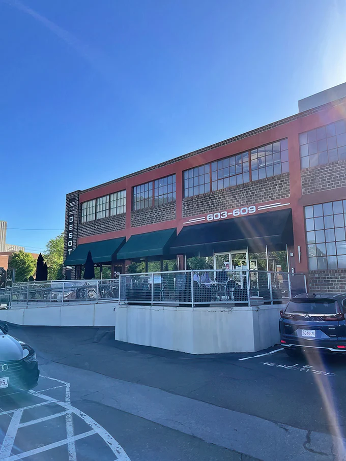 The unassuming red brick exterior of Cyrano's Cafe stands like Clark Kent before transformation – no cape needed, just carrot cake within.