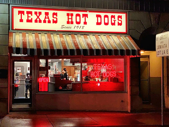 The iconic red and white striped awning of Texas Hot Dogs glows like a beacon for hungry travelers. A slice of Americana preserved on Altoona's 12th Avenue.