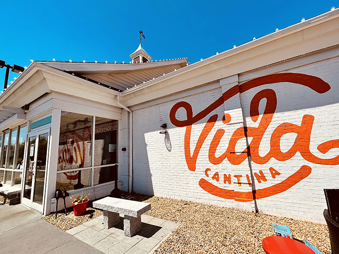 The unassuming exterior hides a culinary fiesta within—like finding a perfect beach behind an ordinary door, Vida Cantina's vibrant orange script promises adventure.