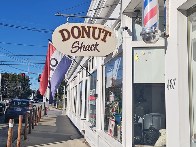 The classic barber pole and vintage sign beckon like an old friend. This modest storefront in Lowell hides donut treasures better than any fancy bakery could dream of. 