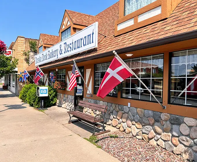 The storybook exterior of Norske Nook beckons like a Norwegian fairytale, complete with stone foundation and flags that say "come hungry, leave happy."