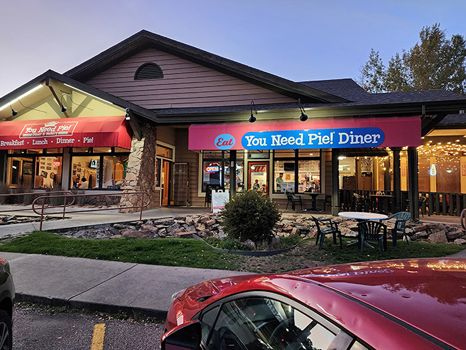 The bright red awning of You Need Pie! Diner isn't just inviting—it's making a bold statement about your immediate dietary requirements.