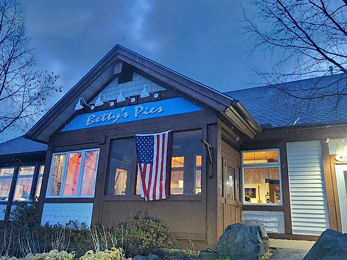 Betty's Pies stands like a North Shore sentinel, its blue sign and American flag promising comfort and sweetness to weary travelers.