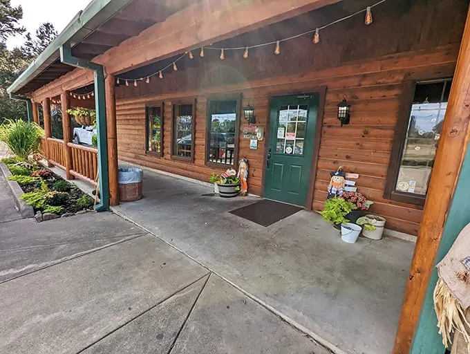The rustic log cabin exterior invites you in with its homey charm, string lights, and green door—like a woodland retreat that happens to serve incredible steaks.