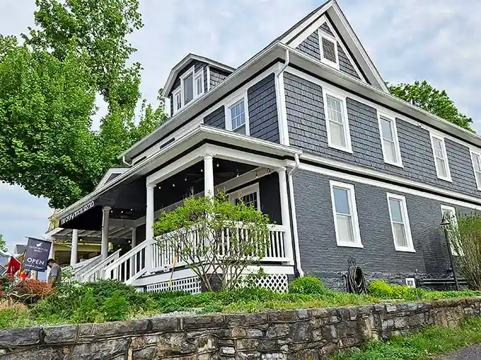 The navy blue colonial exterior of Chop House Bistro stands like a culinary lighthouse in Luray, beckoning hungry travelers with its classic charm and welcoming porch.
