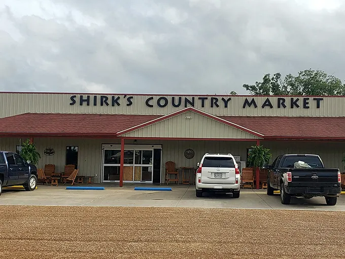 Wooden porch swings beckon hungry travelers outside Shirk's Country Market, where rural charm meets sandwich excellence in Centertown, Missouri.