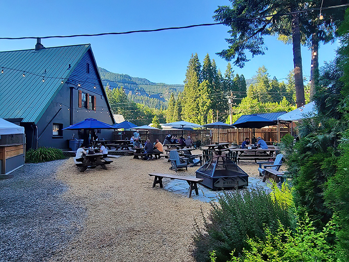 Twilight transforms this charming A-frame into a beacon for hungry travelers. String lights twinkle like fireflies against the green metal roof.