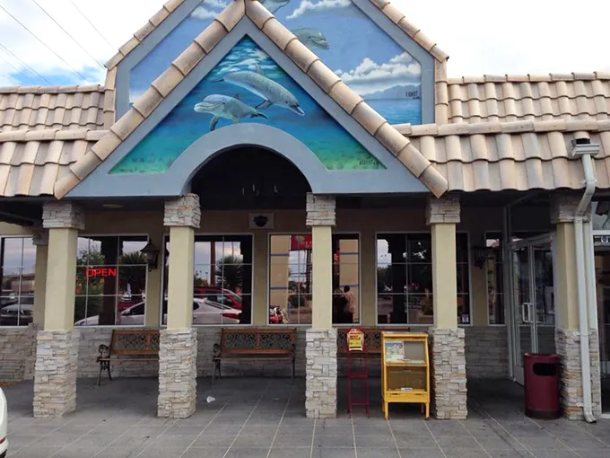 The iconic dolphin mural on Mariscos Altamar's exterior promises an ocean of flavor in the high desert. A seafood mirage that actually delivers.