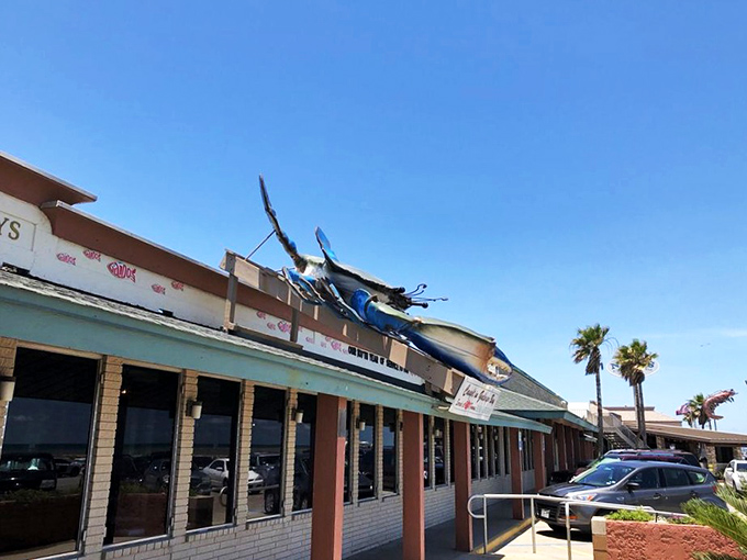 The iconic blue crab perched atop Gaido's isn't just decoration—it's a siren call to seafood lovers that says, "The Gulf's treasures await inside."