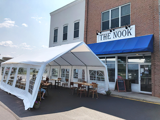 The brick façade and bright blue awning of The Nook stands as Milton's humble breakfast fortress, where culinary magic happens without fanfare or fuss.