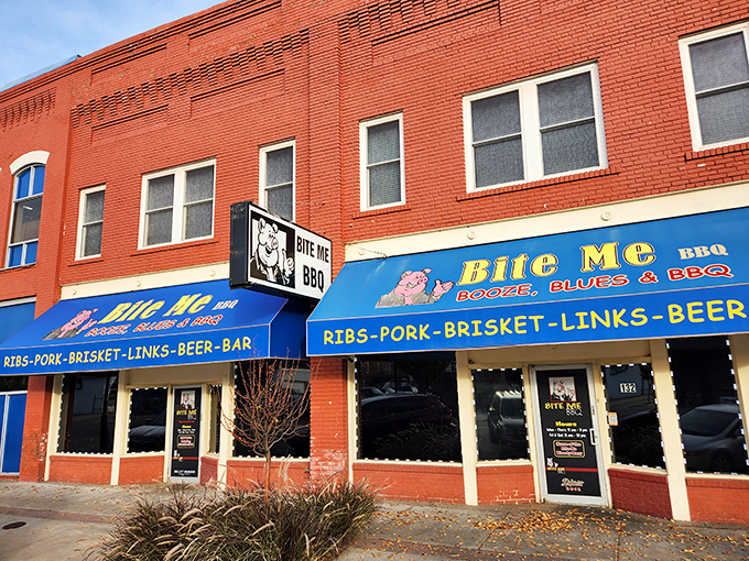 The bright blue awning of Bite Me BBQ stands out like a beacon of smoky hope on Wichita's St. Francis Street, promising delicious rebellion in every bite.