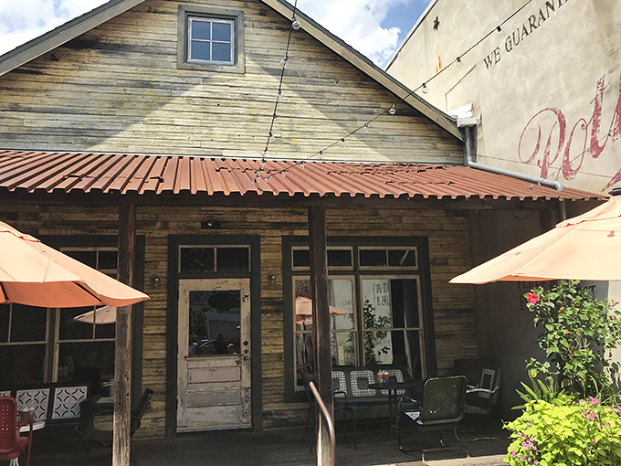 The rustic wooden facade of Fette Sau beckons like a barbecue mirage in Fishtown. Those orange umbrellas aren't just for show—they're meat appreciation stations.
