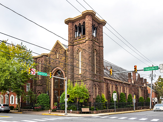 The historic Moravian Church stands as Lititz's architectural crown jewel, its brownstone tower reaching skyward like a sentinel guarding the town's rich heritage.