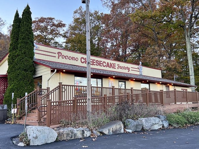 The unassuming exterior of Pocono Cheesecake Factory beckons like a dessert oasis in the woods. Sweet treasures await behind that burgundy sign.